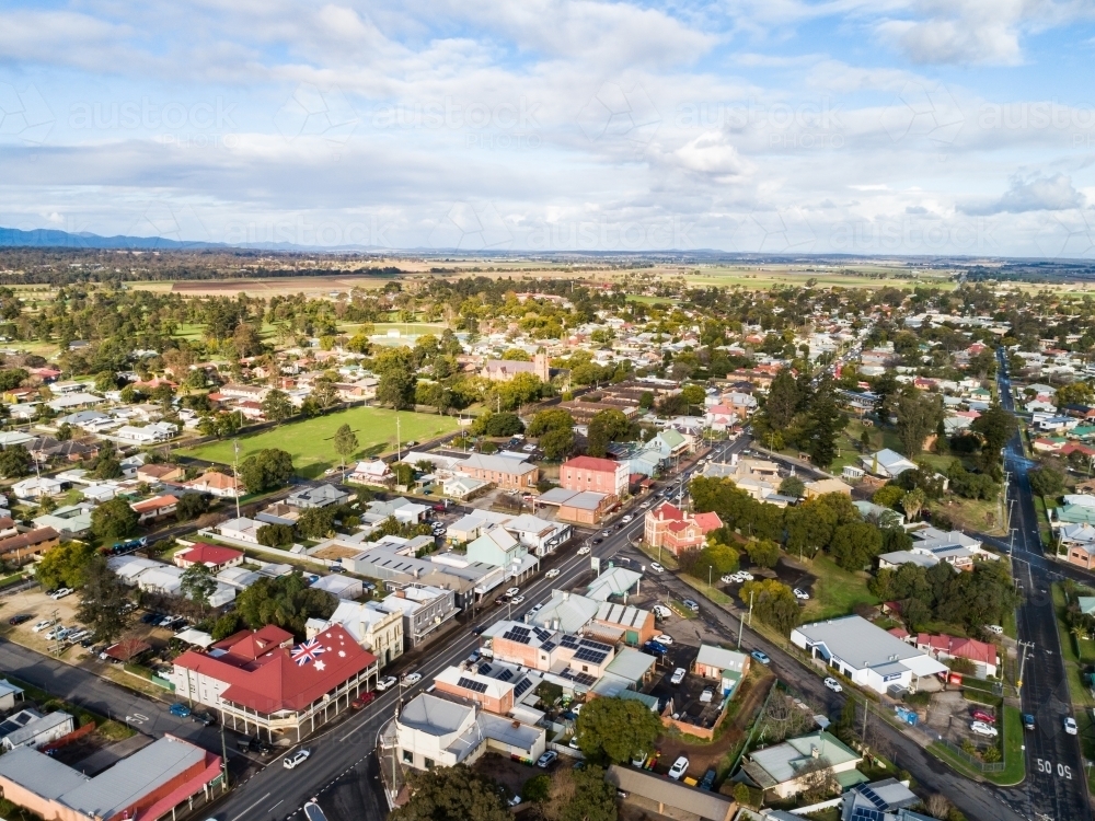 Image of Aerial view of town looking over houses, roads and buildings ...