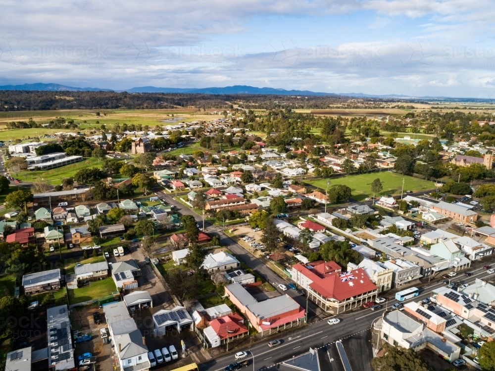 Image of Aerial view of town looking over houses, roads and buildings ...