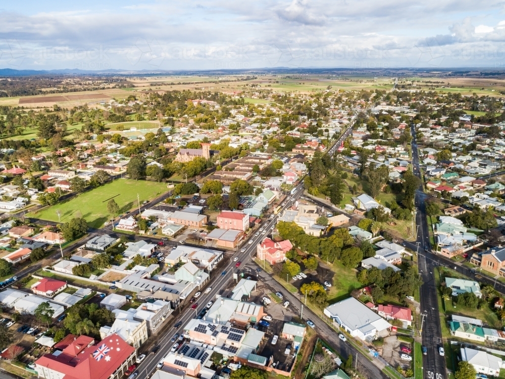 Image of Aerial view of town looking over houses, roads and buildings ...
