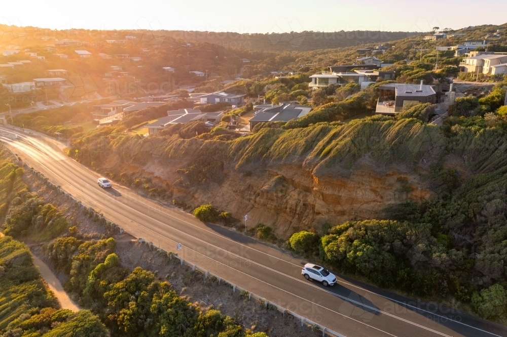 Image of Aerial view of traffic on a high coastal road in late ...