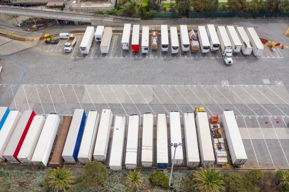 Image of Aerial view of trucks lined up in parking bays at a ferry ...