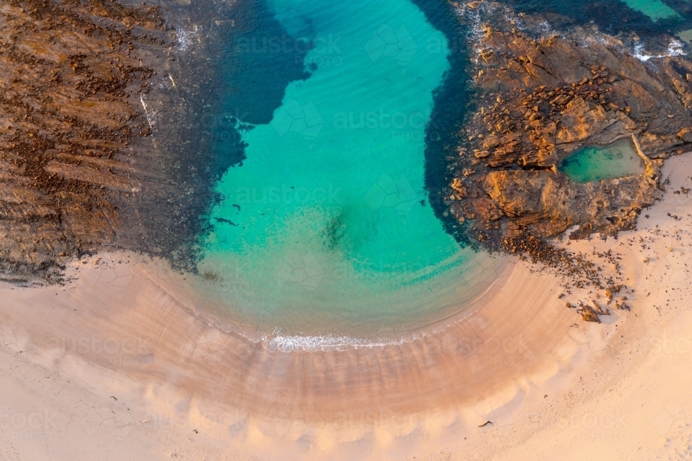 Image of Aerial view of turquoise water in a large rockpool and a ...