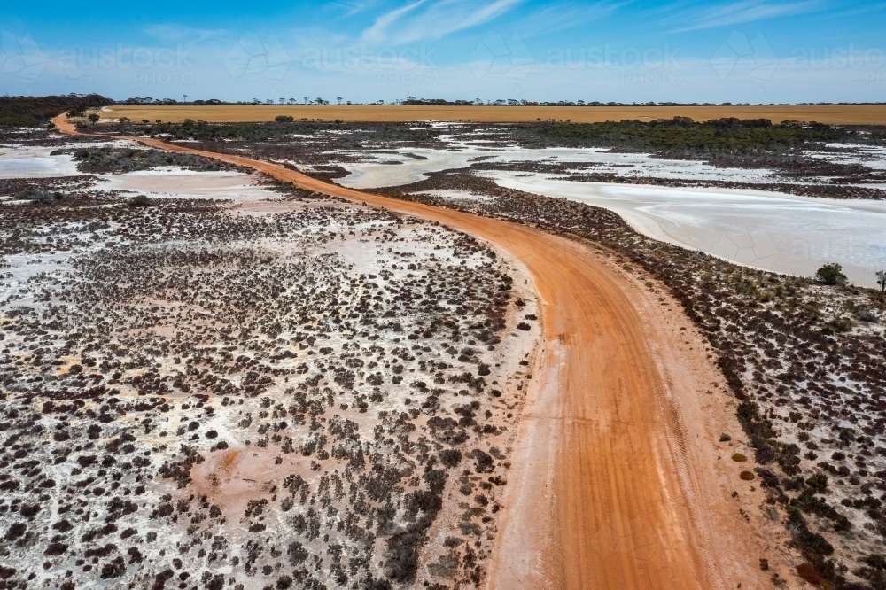 Image of Aerial view of unsealed road winding through salt pans ...