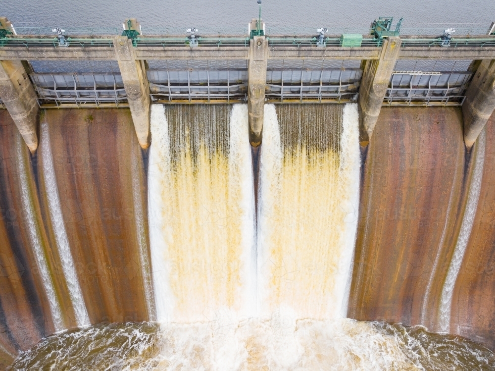 Image of Aerial view of water spilling over a weir from a reservoir ...