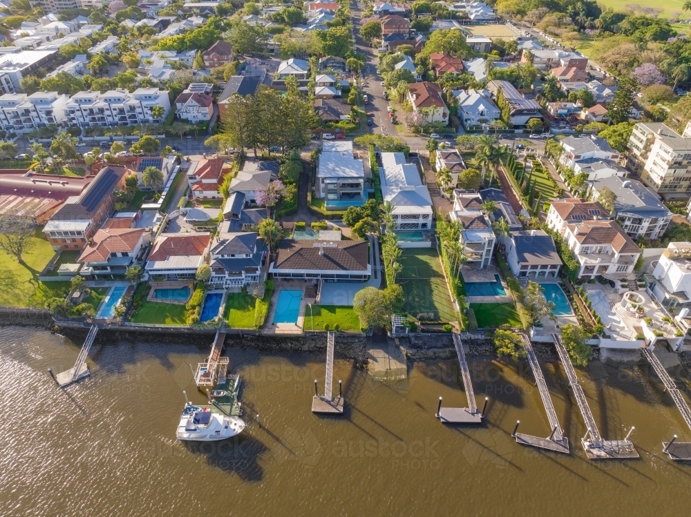 Image of Aerial view of waterfront real estate with jetties and ...