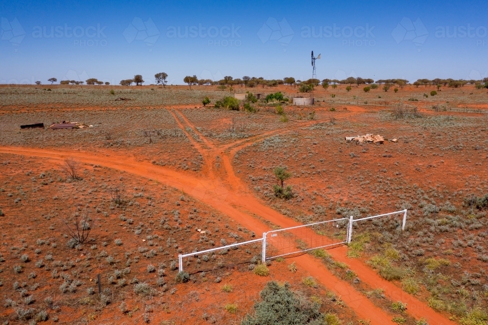 Image of Aerial view of wheel tracks in red dirt going through a ...