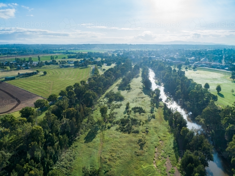 Image of Aerial view or green grass at riverside with morning sunlight ...
