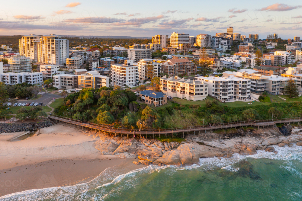 Image of Aerial view over a coastal city with highrise buildings at ...