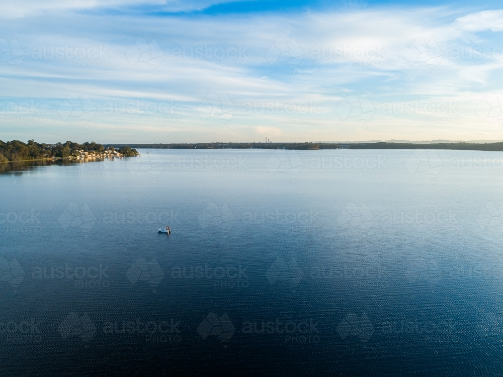 Image of Aerial view over calm blue coastal lake waters - Austockphoto