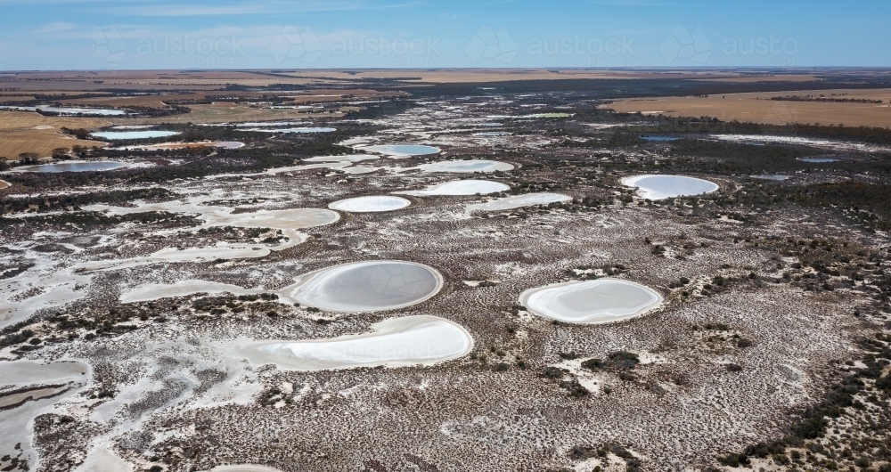 Image of aerial view over chain of salt lakes in arid landscape ...