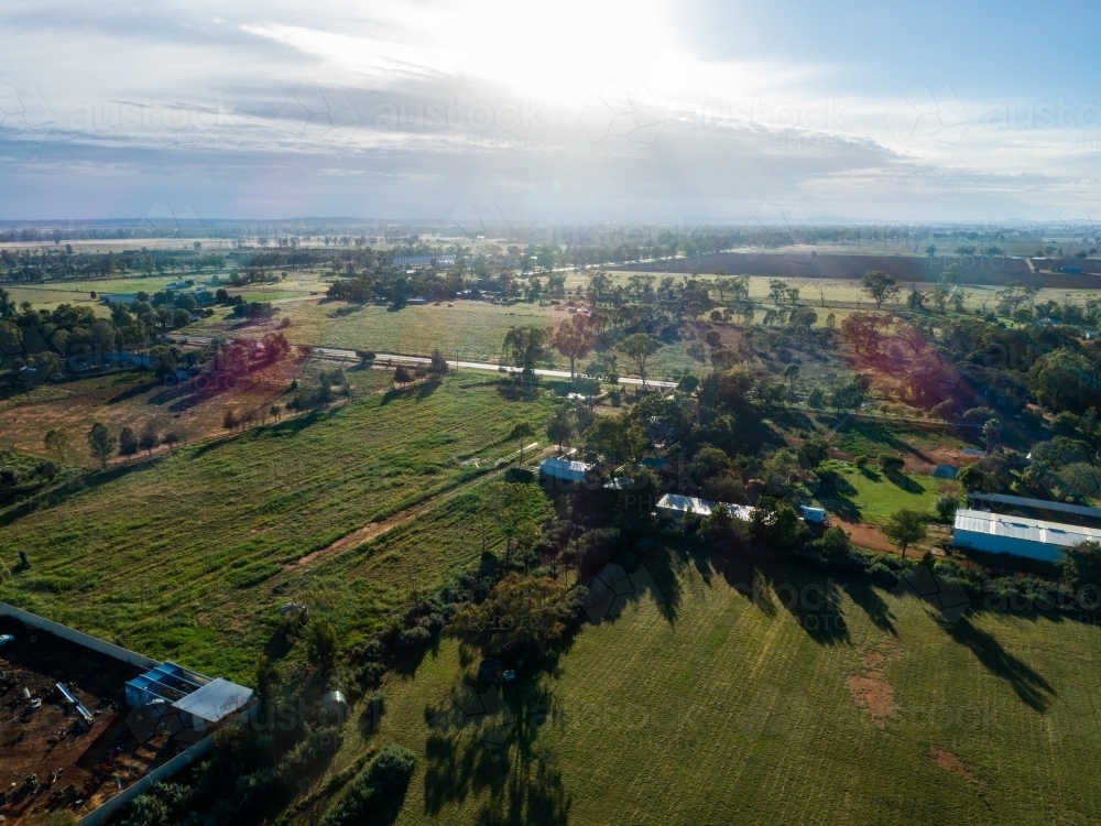 Image of Aerial view over green farm paddocks and properties in good ...