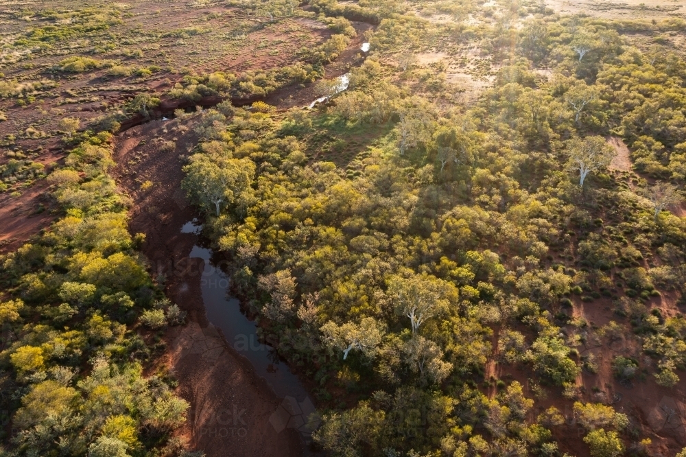 Image of aerial view over pilbara lansdcape with watercourse winding ...