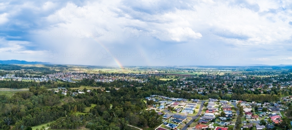 Image of Aerial view over residential area of town, rainfall and ...