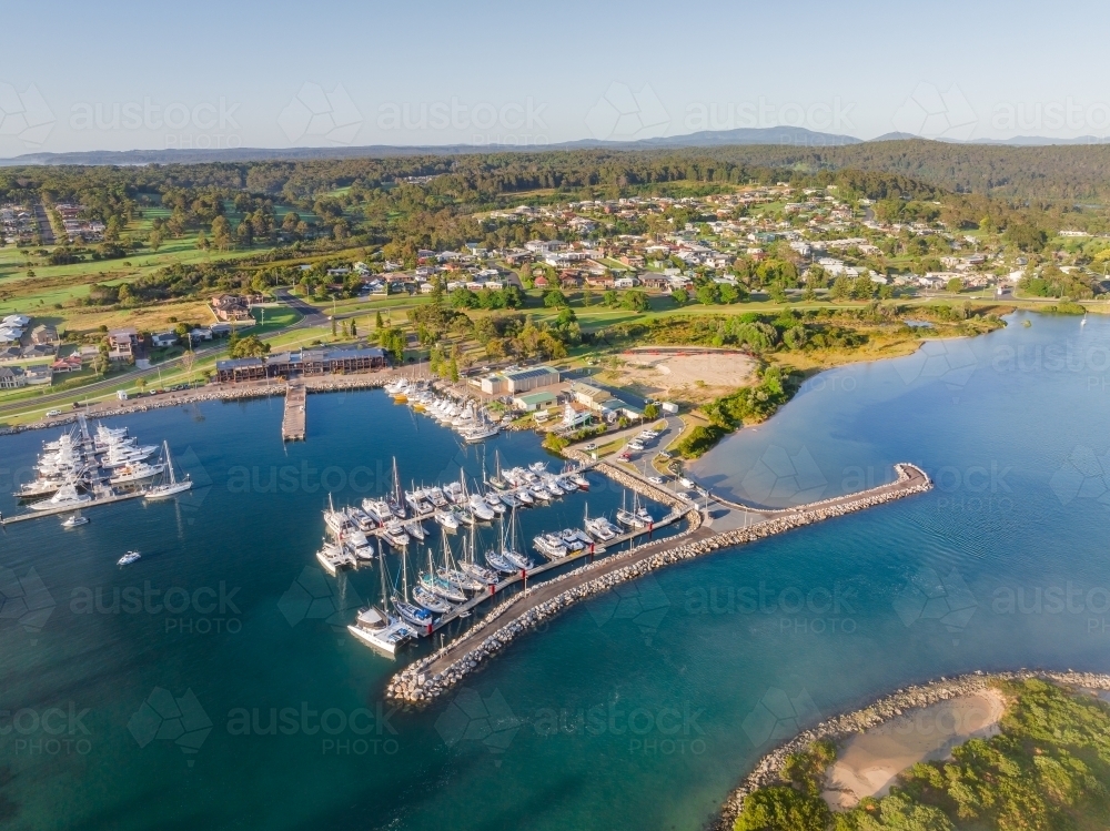 Image of Aerial view over rows of boats moored along a jetty in a ...