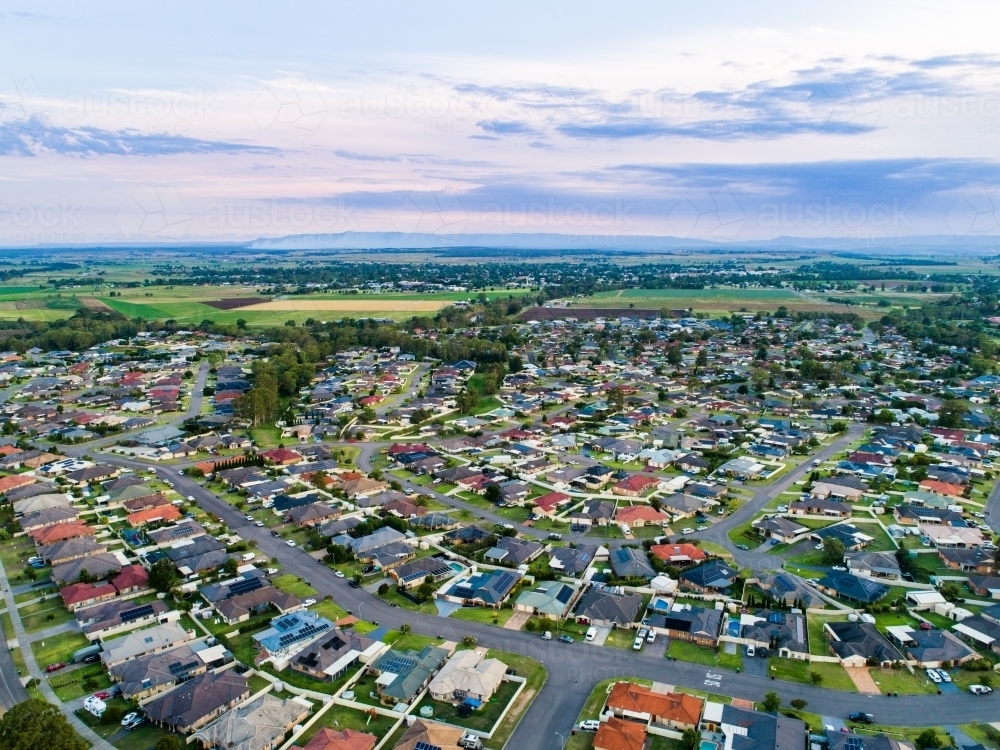 Image of Aerial view over suburbia - streets and homes in country town ...