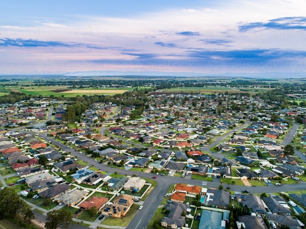 Image of Aerial view over suburbia - streets and homes in country town ...