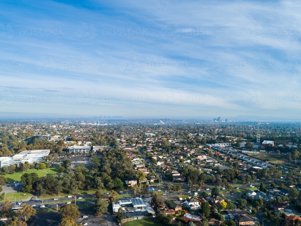 Image of Aerial view overlooking Melbourne suburbia with city shrouded ...