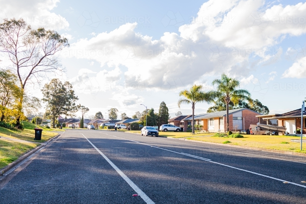 Image of Afternoon light over street in suburban residential area with ...