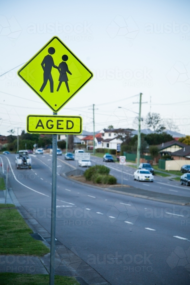 Image of AGED yellow reflective sign beside busy road in Newcastle ...