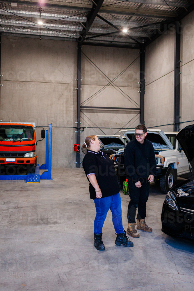 Image of air conditioner technician talking with customer about car in ...