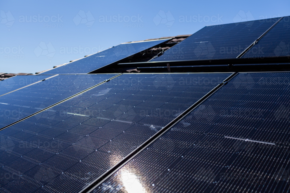 Image of All Black bifacial solar panels on roof being installed and ...