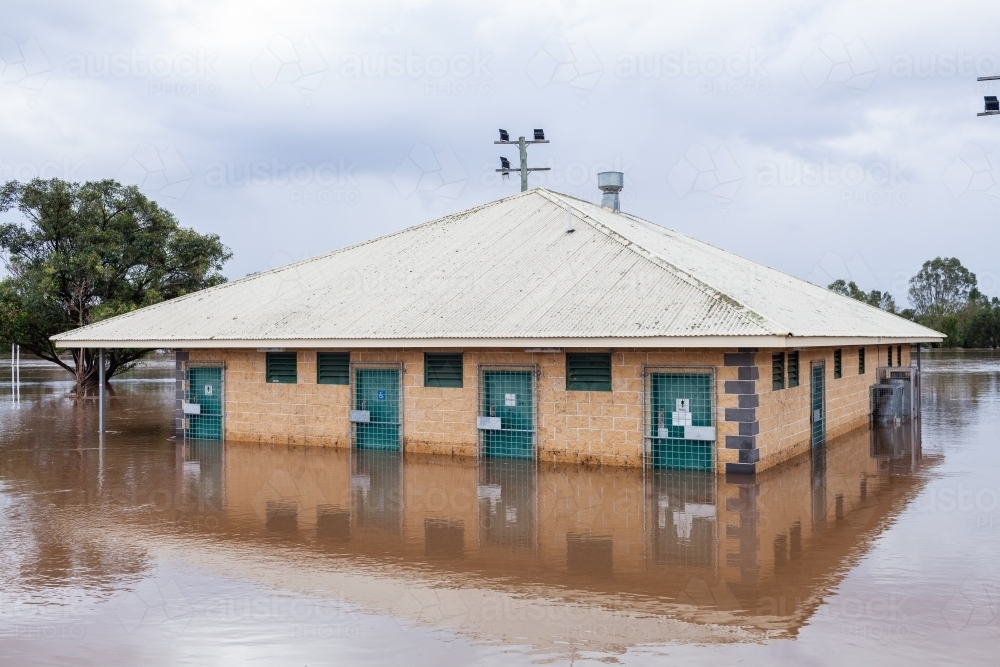 Image of amenities in sports field building underwater during flood ...