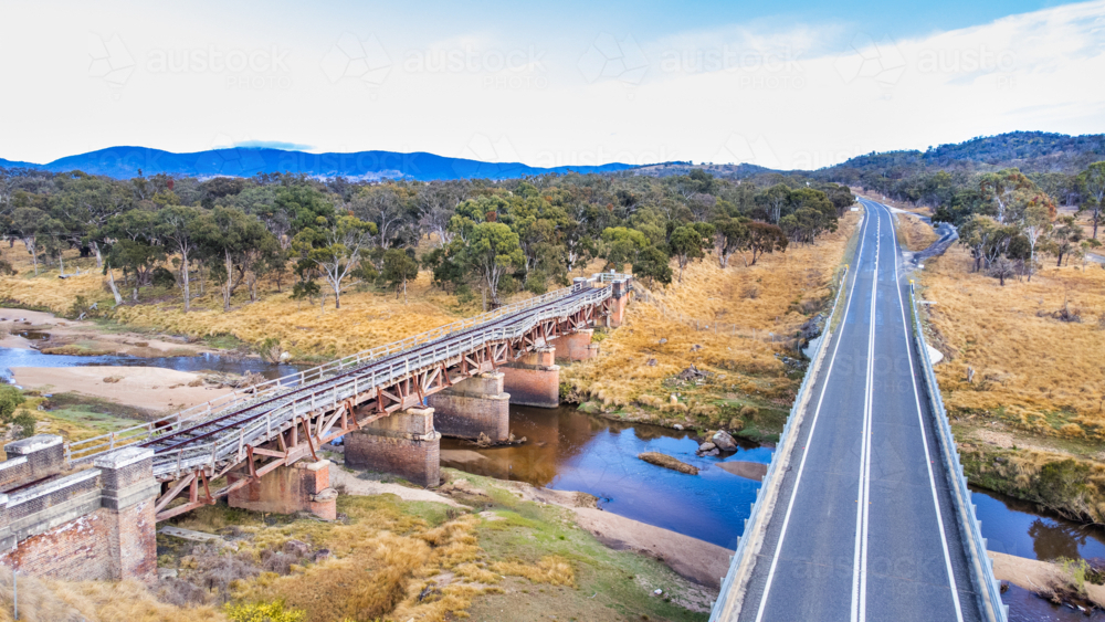 Image of An aerial shot of a country highway and an old bridge ...