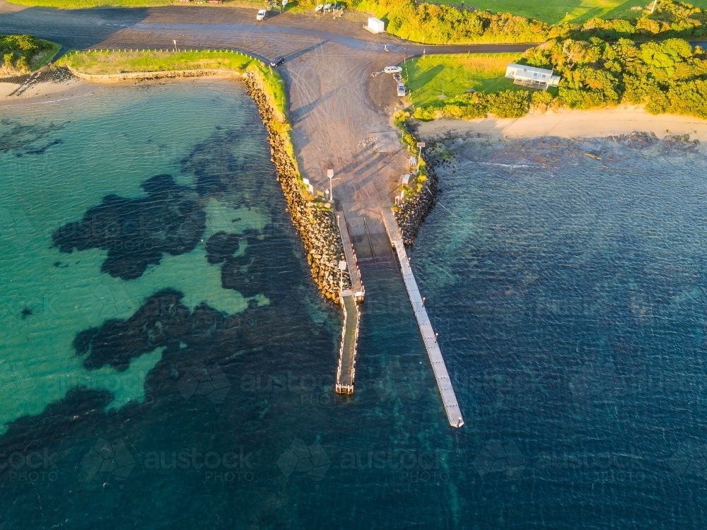 Image of An aerial view of a boat ramp and jetty at a coastal marina ...