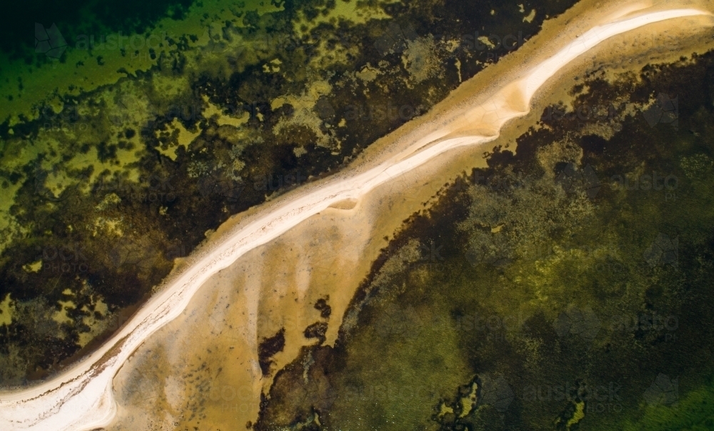 Image of An aerial view of a sandbank partially covered by water ...