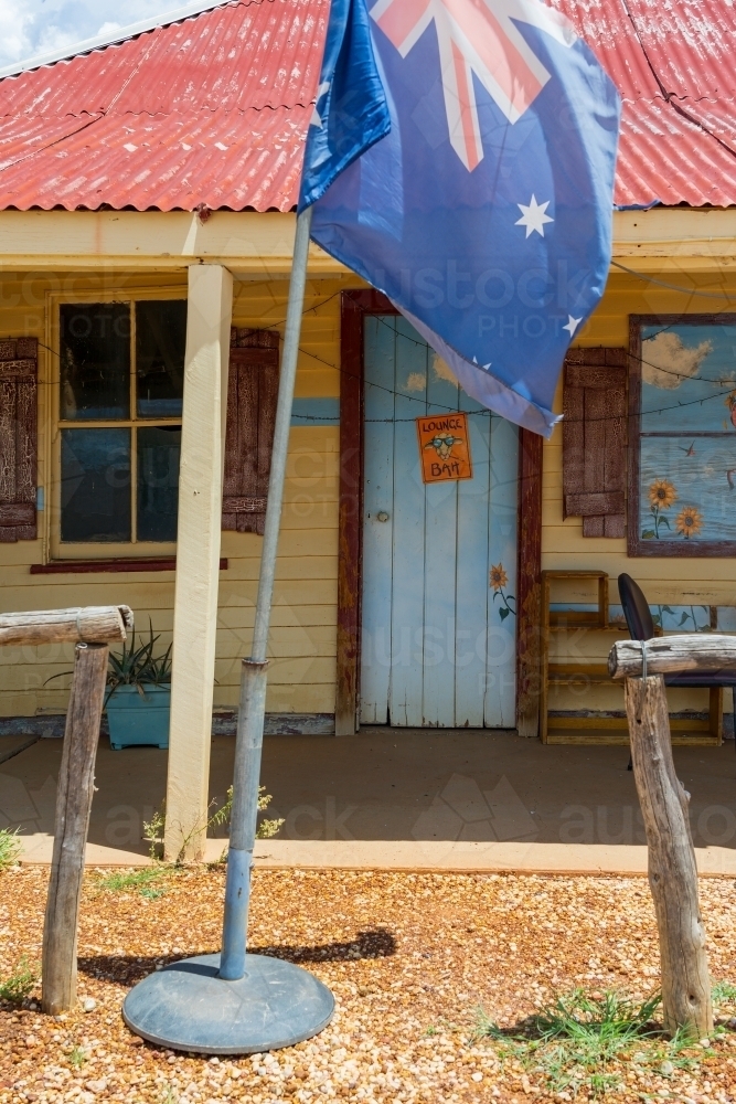Image of An Australian flag in a stand in front of an outback pub with ...