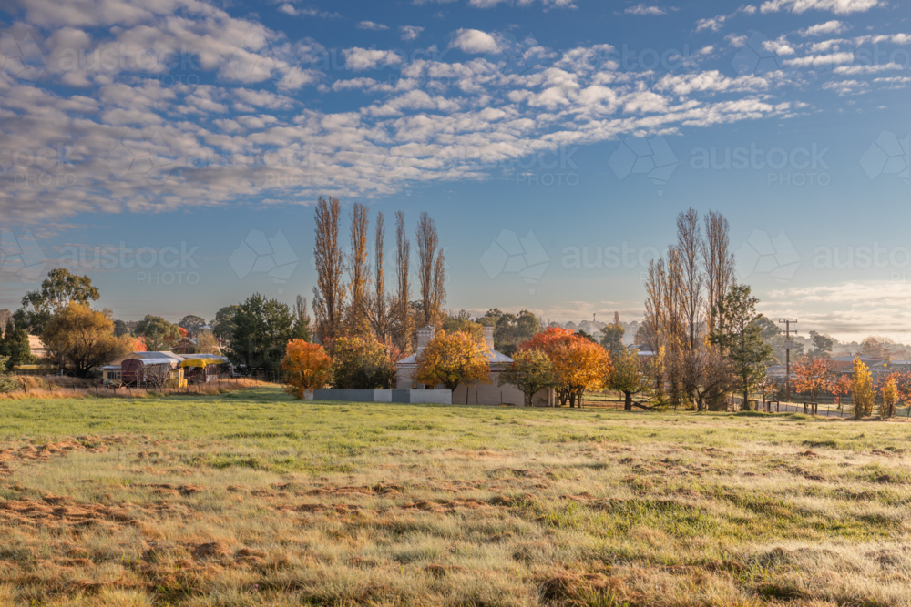 Image of An autumn scene in the country under a blue sky - Austockphoto