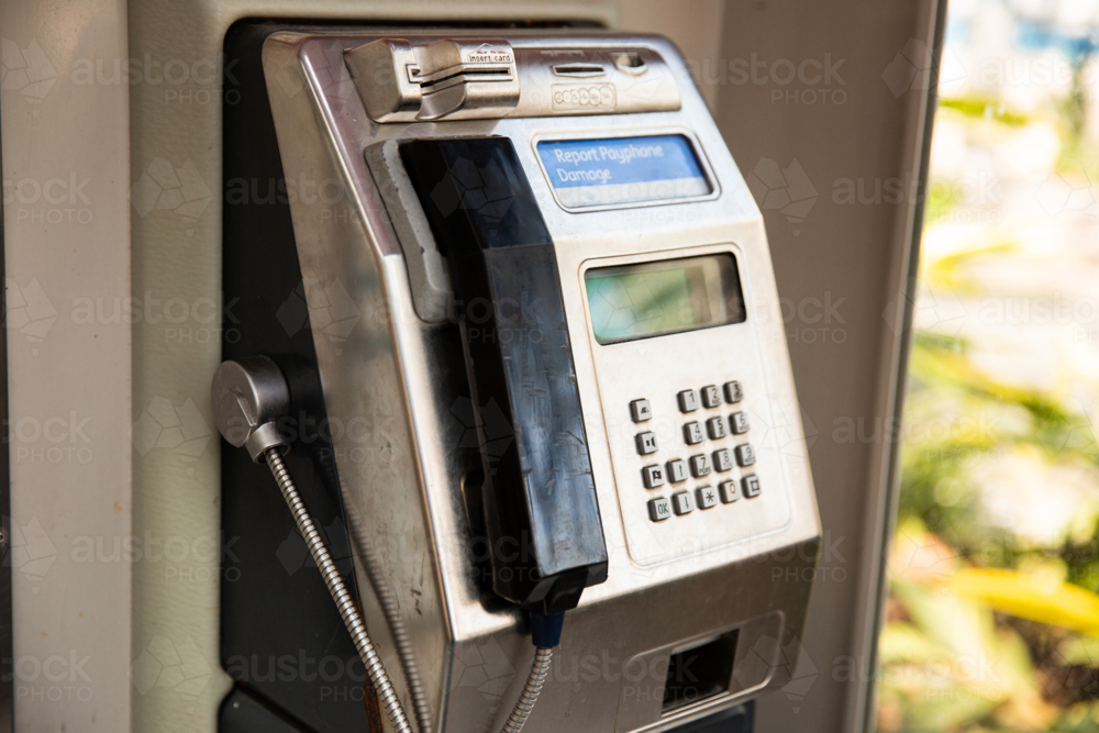 Image of an old metal public payphone with black plastic receiver ...