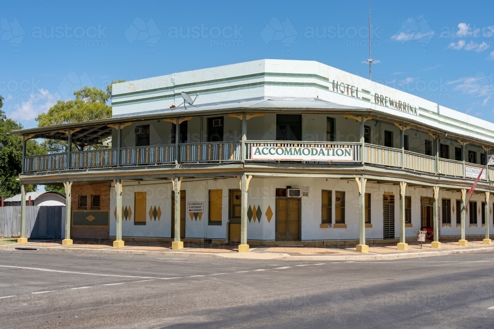 Image of An old two storey hotel on a street corner with a balcony ...