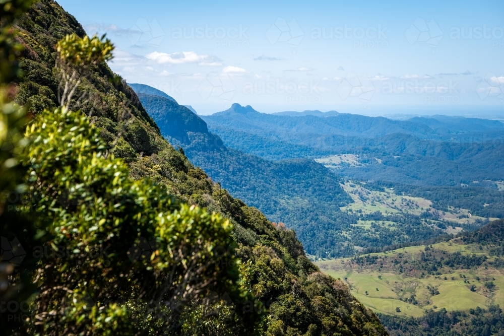Image of An overlooking view of the rolling hills and mountain ranges ...