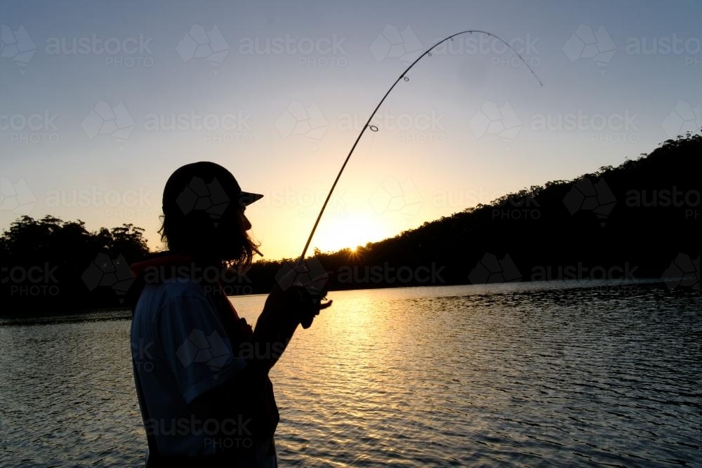 Image of Angler at Sunset - Austockphoto
