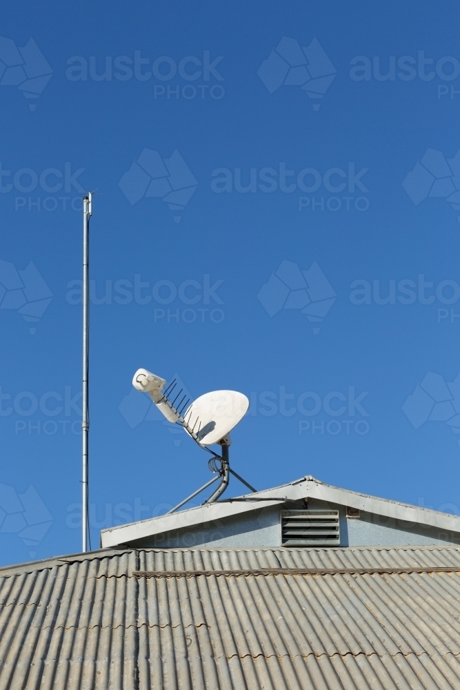Image of Antenna and satellite dish on tin roof - Austockphoto