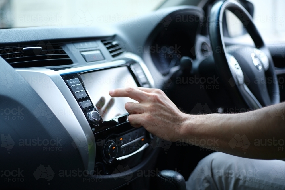Image of Arm of a person using car dashboard screen - Austockphoto