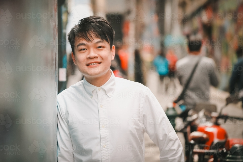 Image of Asian man leaning against wall in Hosier Lane, iconic graffiti ...