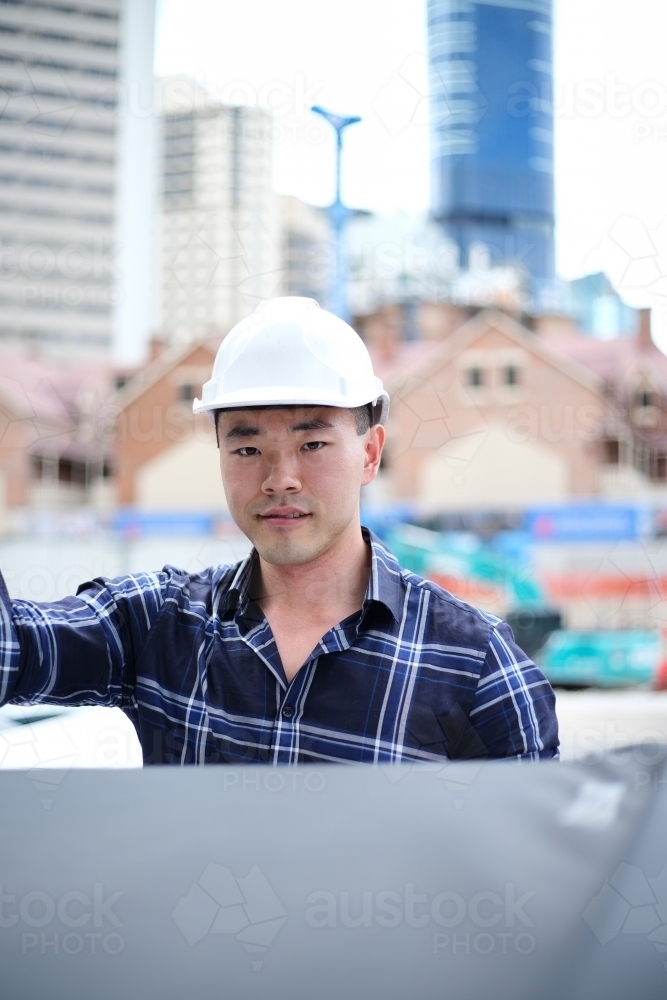 Image of Asian man wearing hard hat - Austockphoto