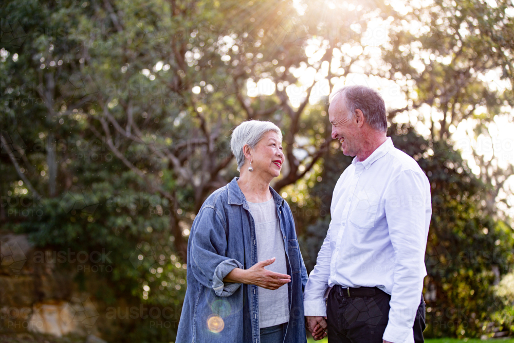 Image of Asian senior woman looking at her partner happily at the ...