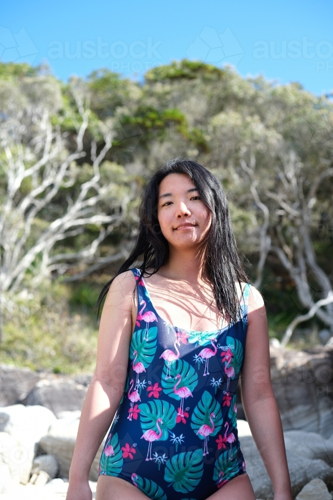 Image of Asian woman in her colourful swimwear on australian beach ...