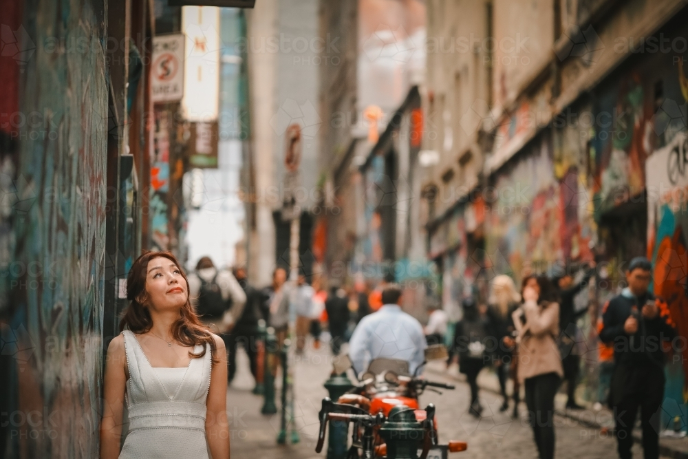 Image of Asian woman leaning against wall in Hosier Lane, iconic ...
