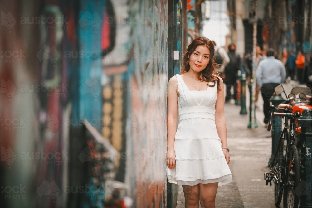 Image of Asian woman leaning against wall in Hosier Lane, iconic ...