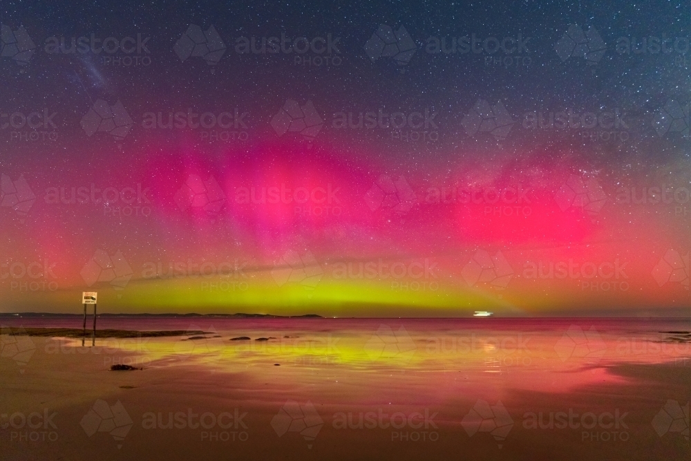 Image of Aurora Australia illuminating the night sky and reflecting on ...