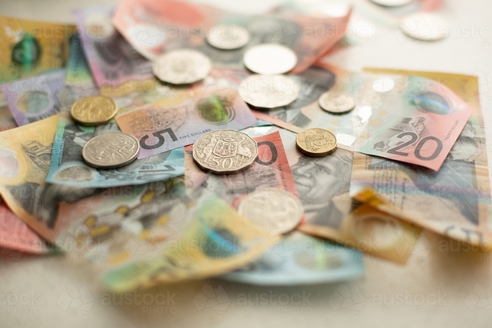 Image of Aussie money in a pile on a white kitchen benchtop - Austockphoto