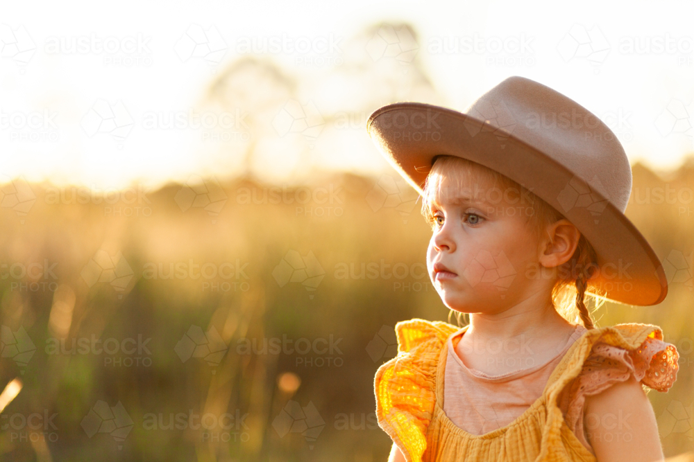 Image of Aussie toddler in akubra hat looking off to side - Austockphoto
