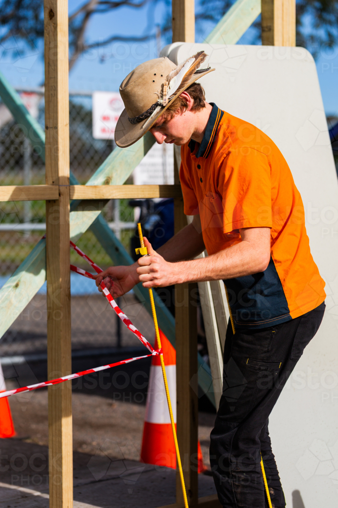 Image of Aussie trade apprentice worker marking off work area with ...
