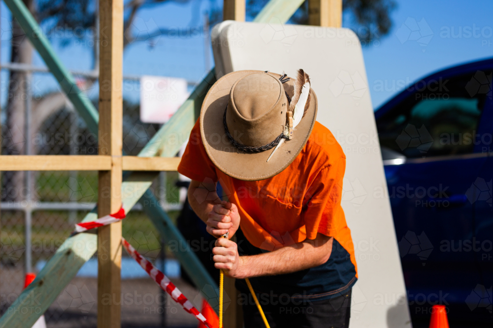 Image of Aussie trade apprentice worker marking off work area with ...