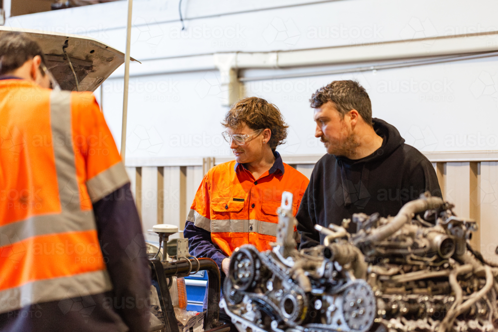 Image of Aussie workmen mechanics inspecting vehicle internal engine ...