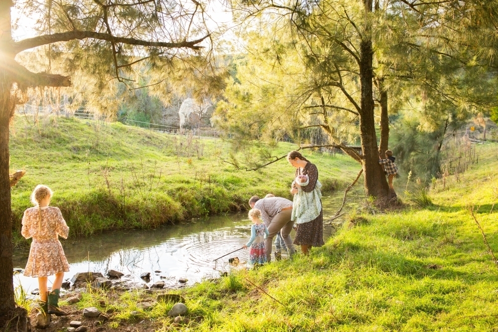 Image of Australian family playing together down by the creek on their ...